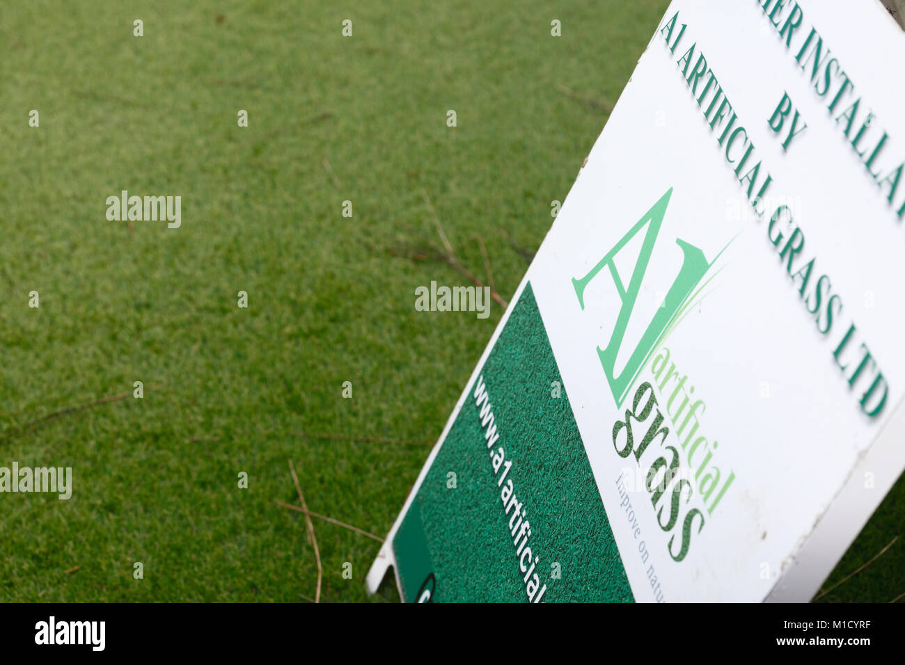 Advertising board at an installation of artificial grass hi-res stock ...