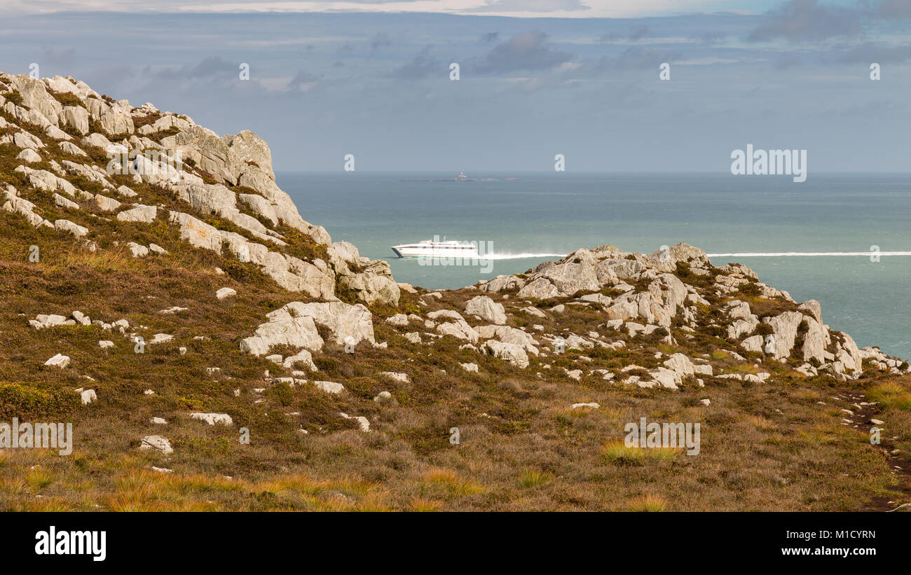 View towards the sea with a ship passing by between Holyhead Breakwater ...