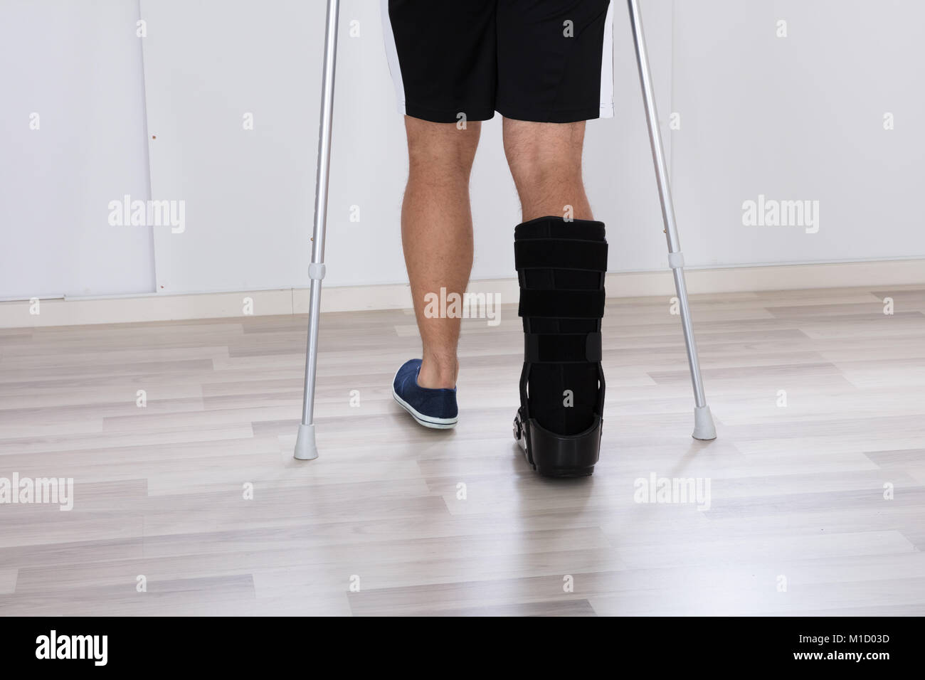 Low Section View Of A Injured Person's Leg With Crutches And Walking ...