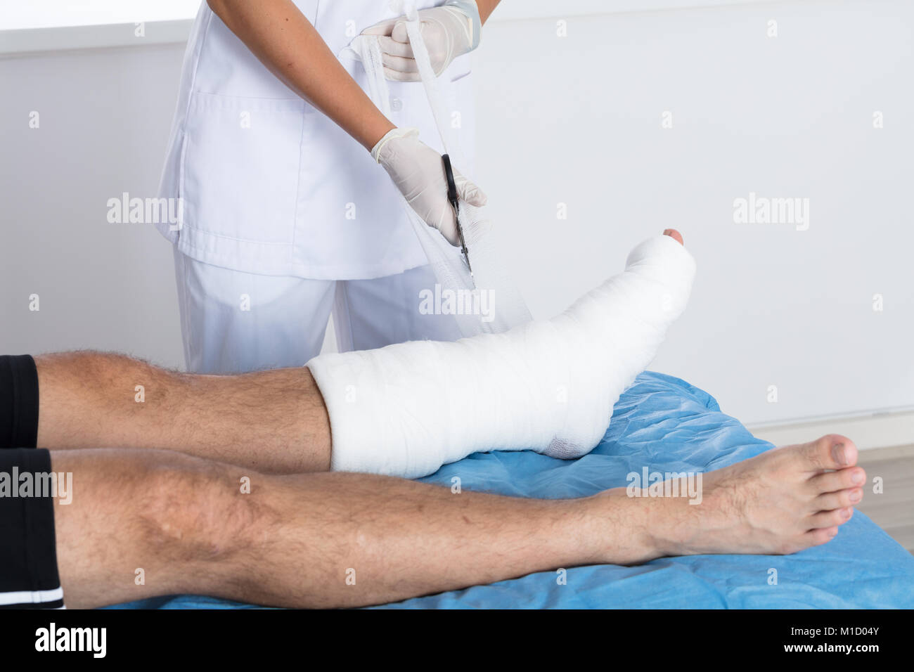 Close-up Of A Doctor's Hand Tying Bandage On Person's Foot In Clinic ...