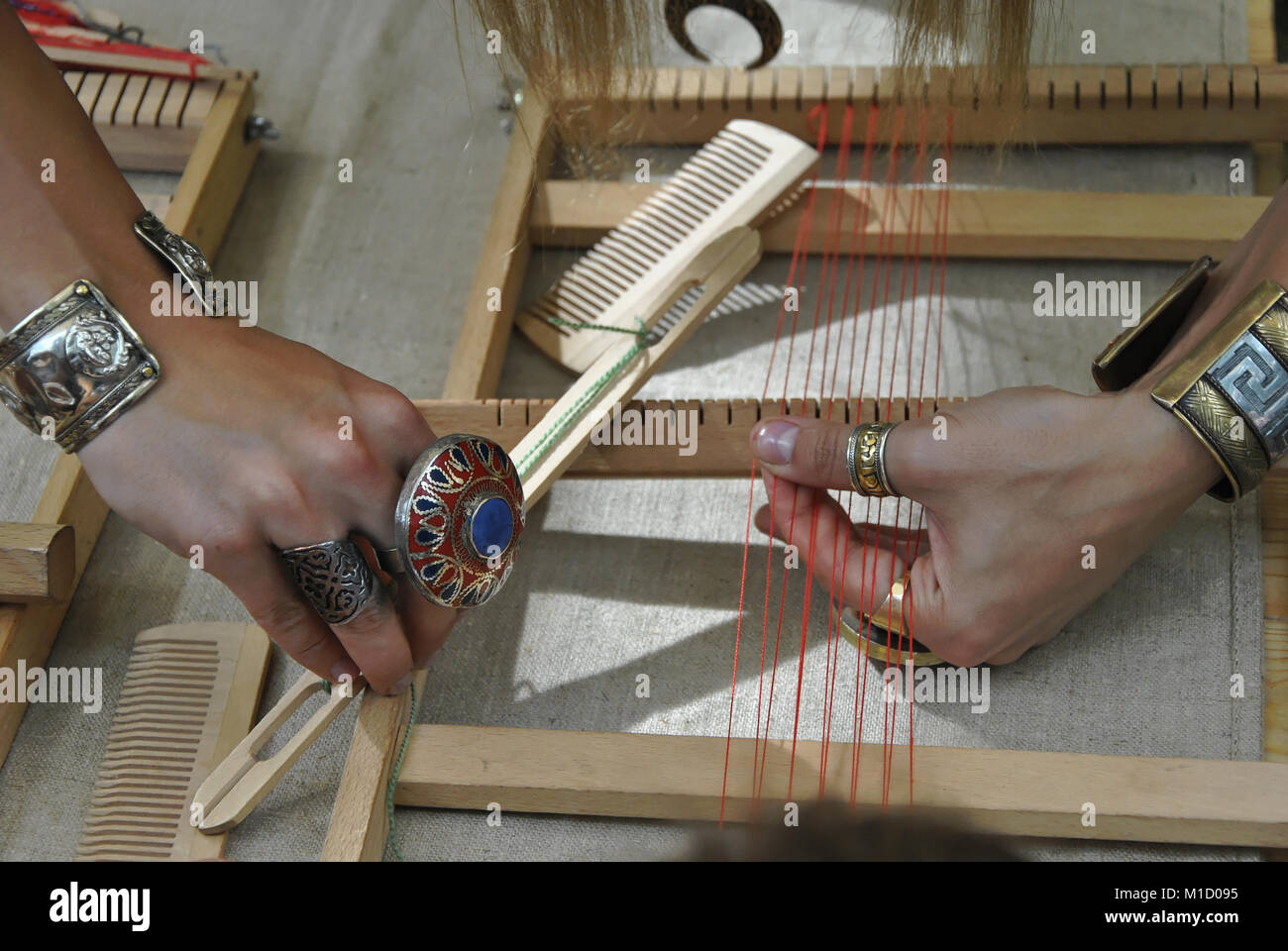 Woman using simple frame loom Stock Photo - Alamy