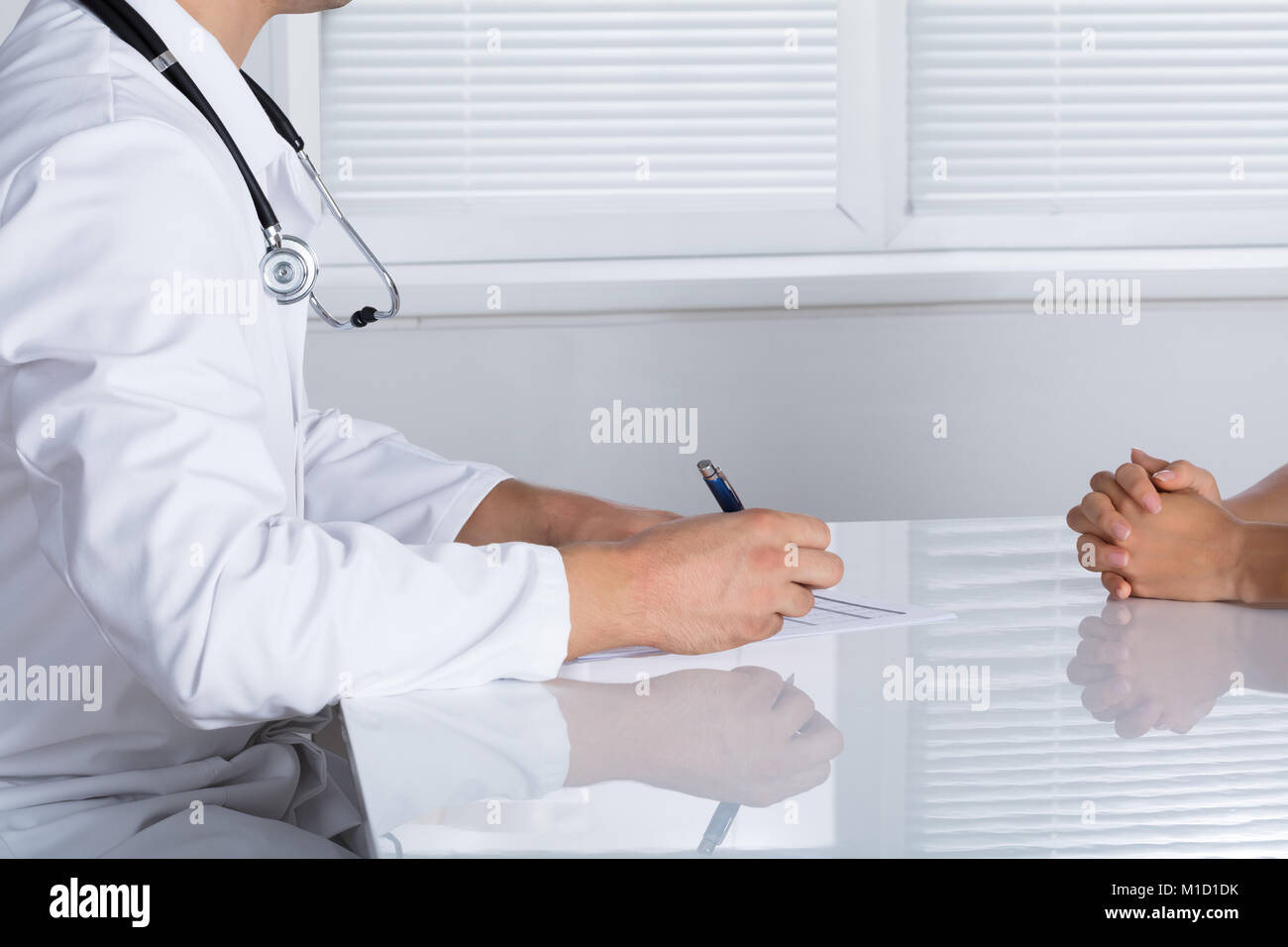 Medical doctor writing prescription in hi-res stock photography and ...