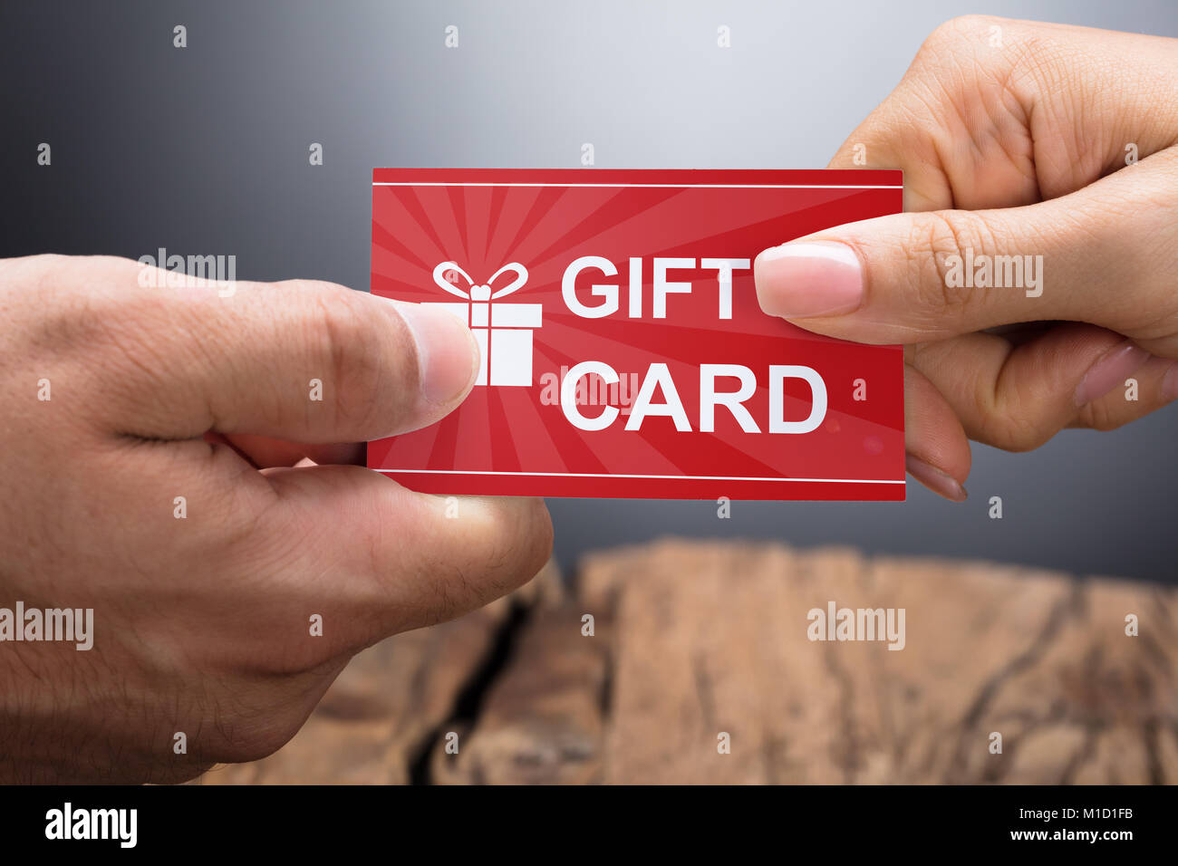 Close-up Photo Of Hands Exchanging Gift Card Stock Photo - Alamy
