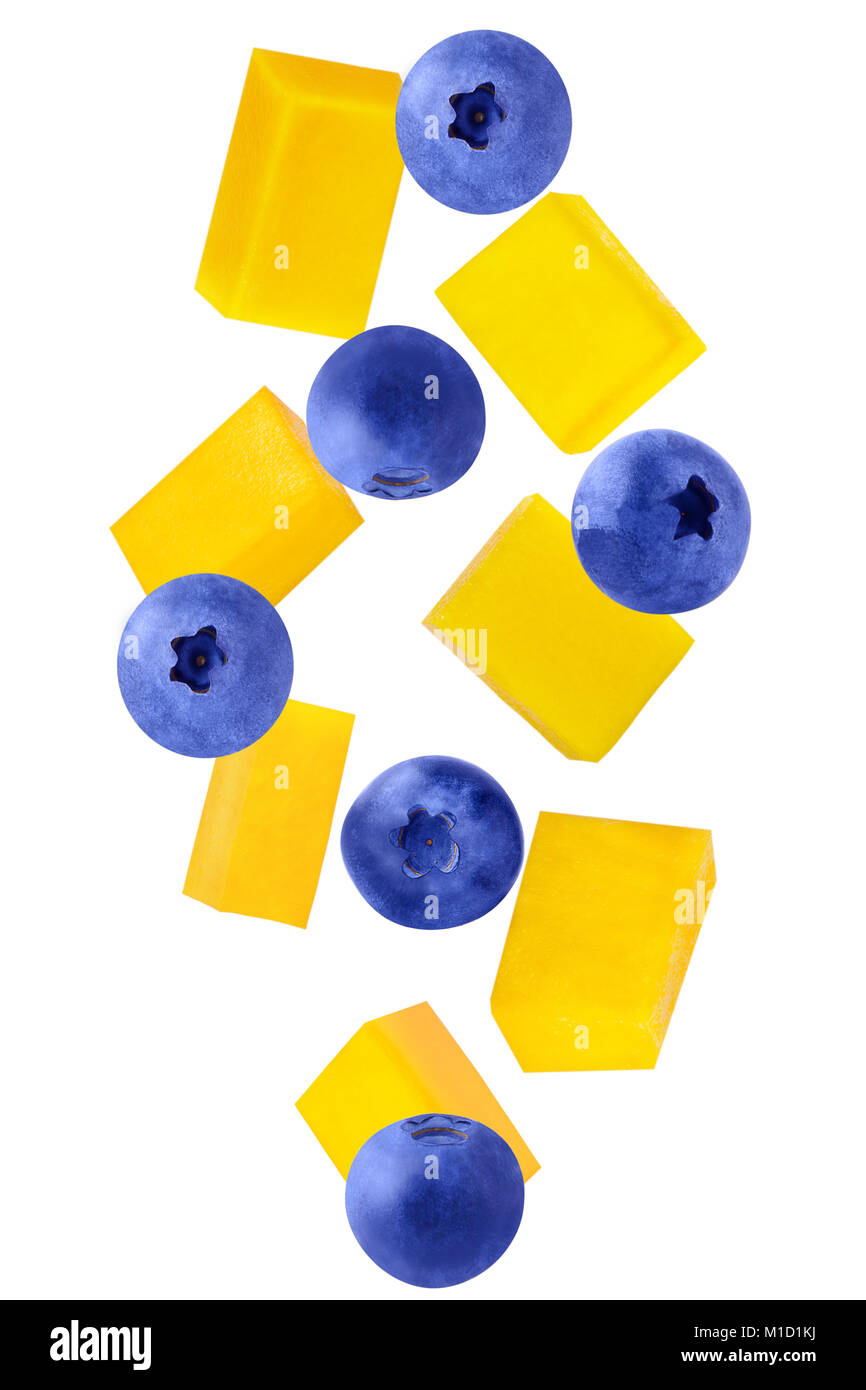 Isolated falling fruits. Falling mango and blueberries isolated on ...