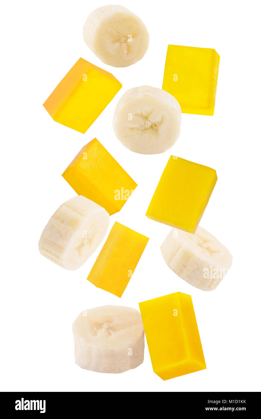 Isolated falling fruits. Falling sliced banana and mango isolated on ...