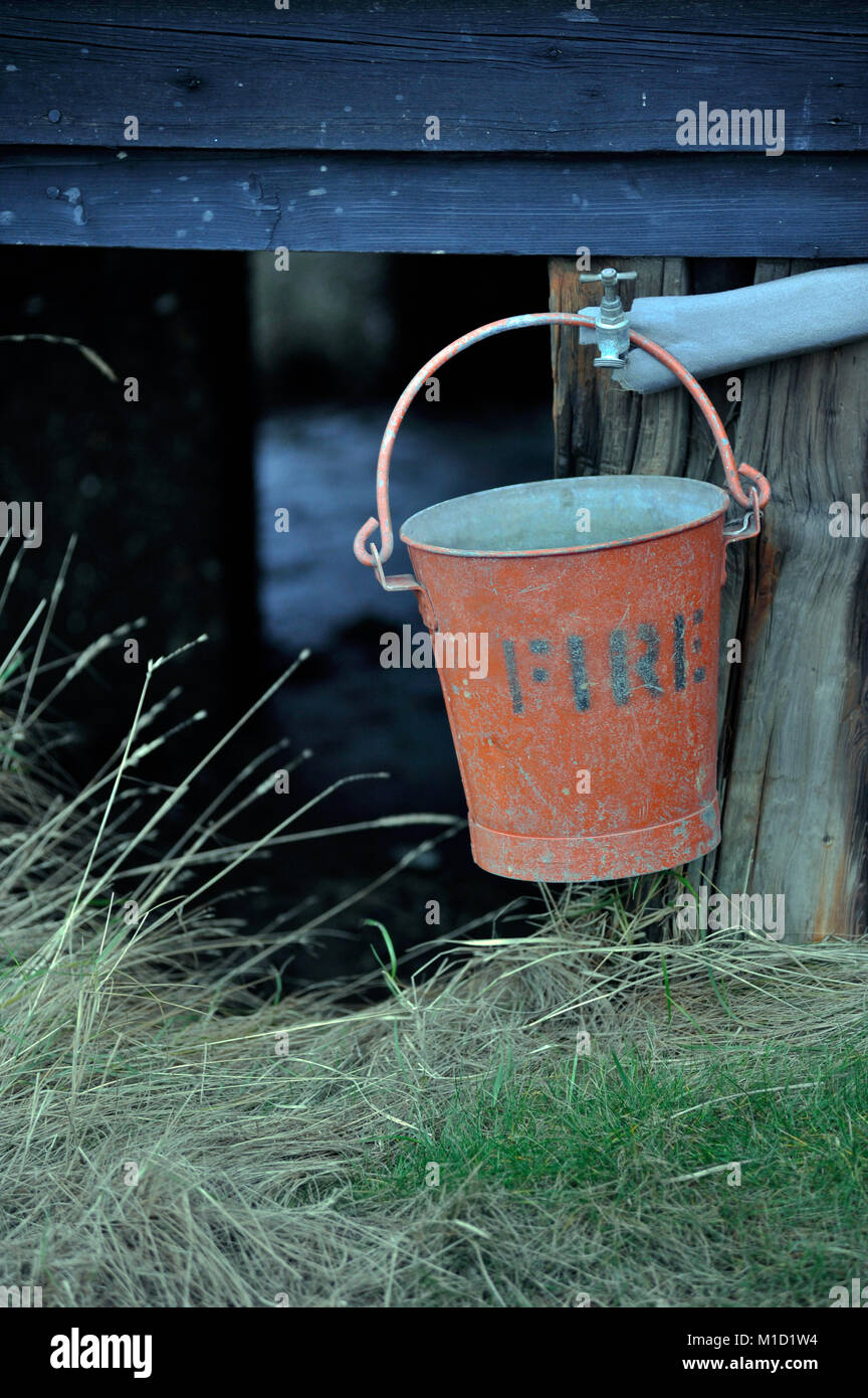 fire bucket hanging outside wooden house Stock Photo - Alamy