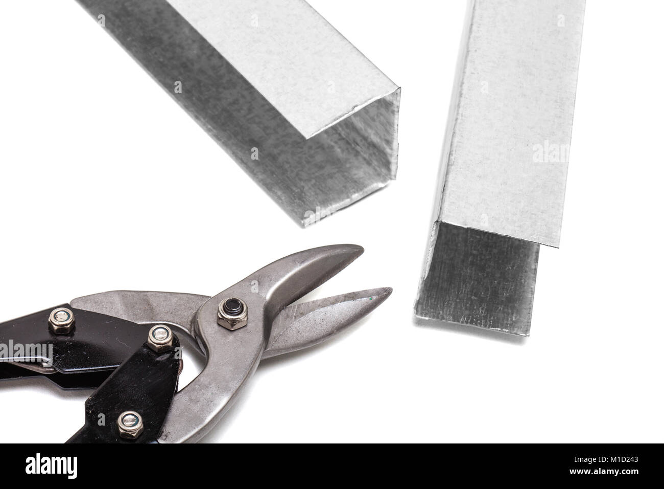 industrial scissors cutting U-shaped metal profile for drywall support ...