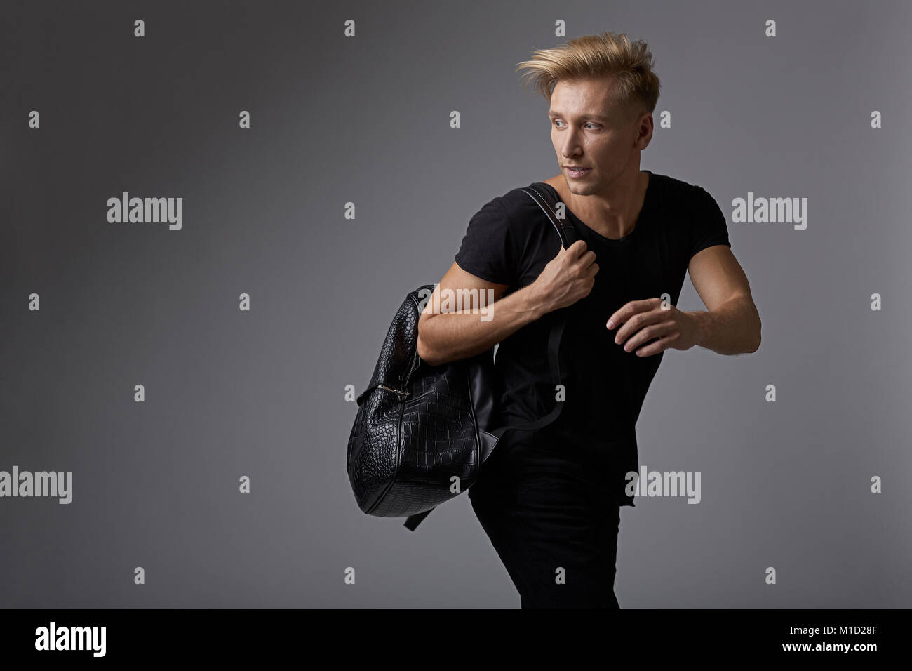 Handsome young man running with a backpack on shoulders Stock Photo - Alamy