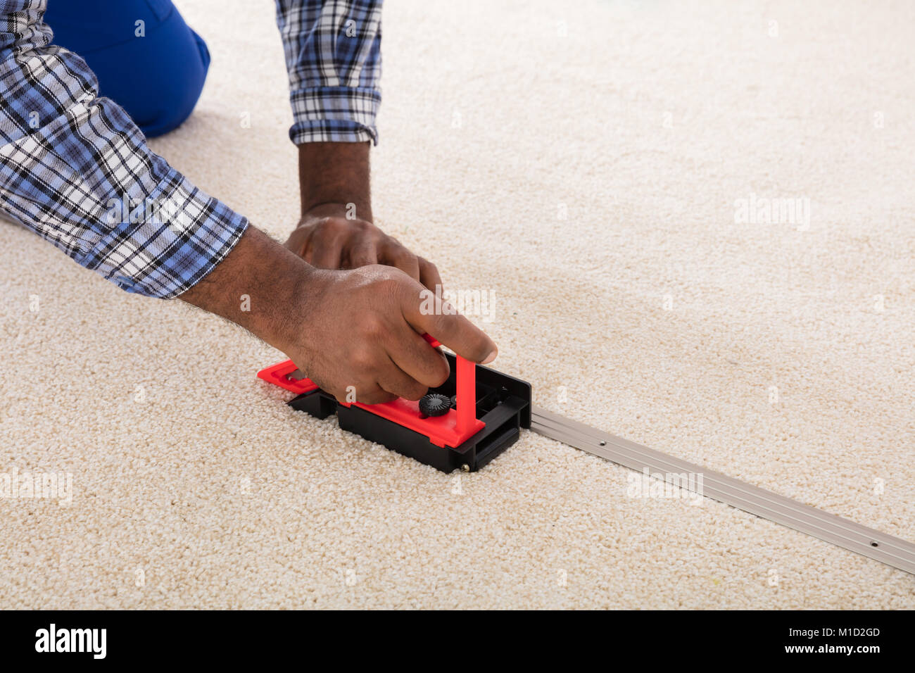 Craftsman Installing Carpet On Floor Using Fitter Stock Photo - Alamy