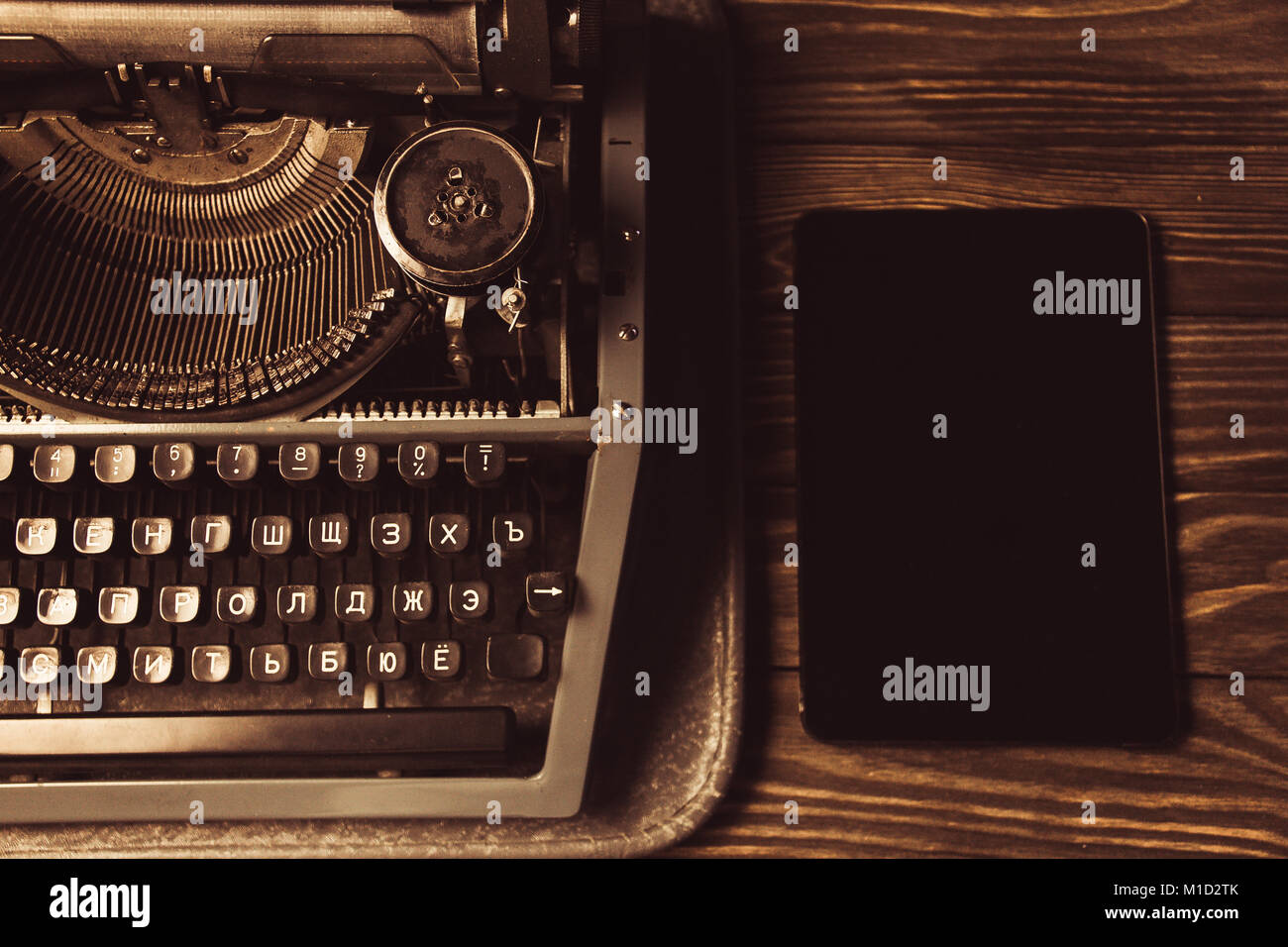 typewriter and a modern gadget. new technology Stock Photo - Alamy