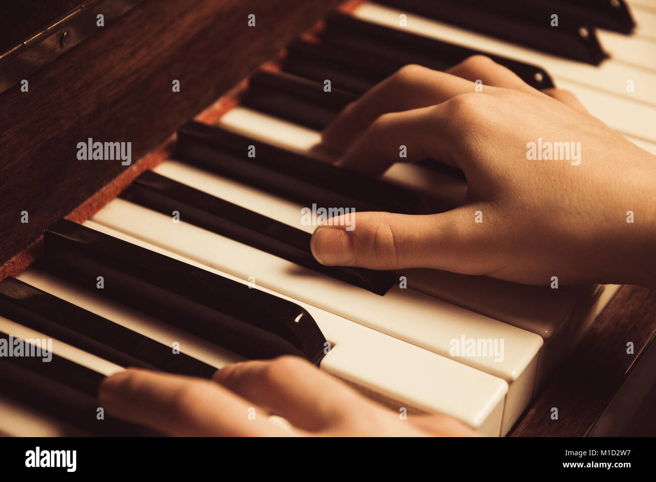 the hands on the piano keys. Photo piano in retro style Stock Photo - Alamy
