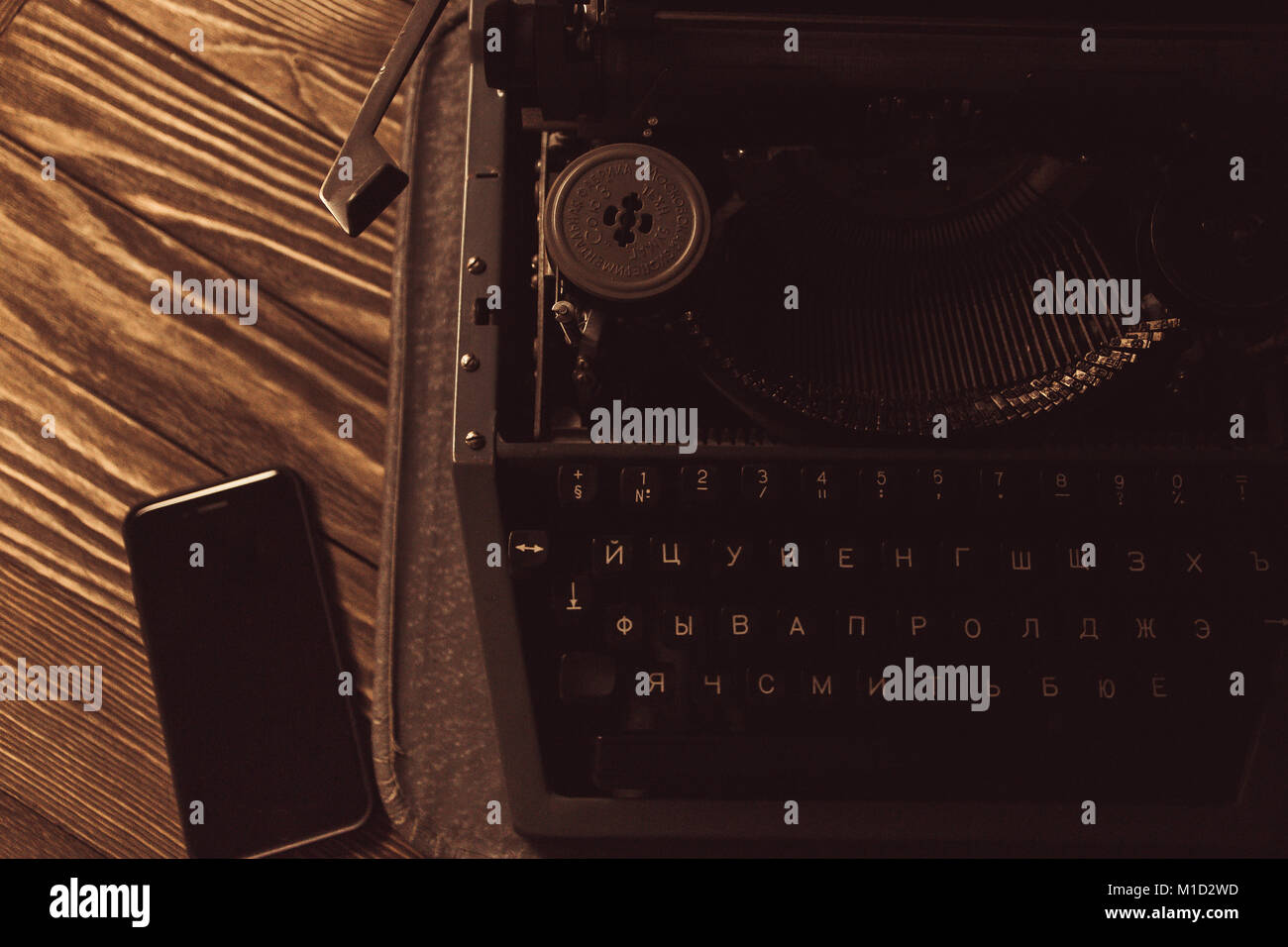 typewriter and a modern gadget. new technology Stock Photo - Alamy
