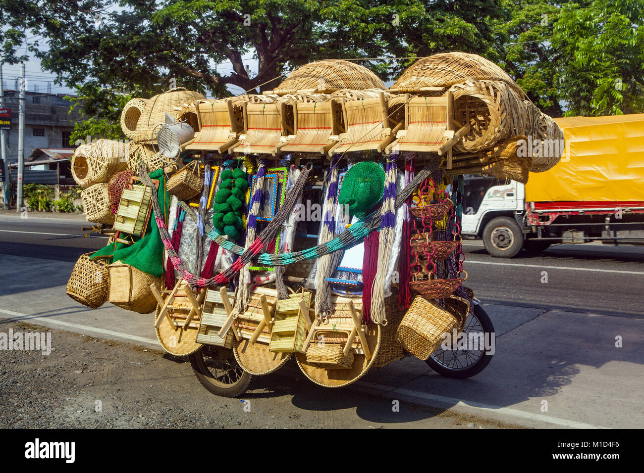 A motorcycle is stacked with an impressive load of woven baskets and ...