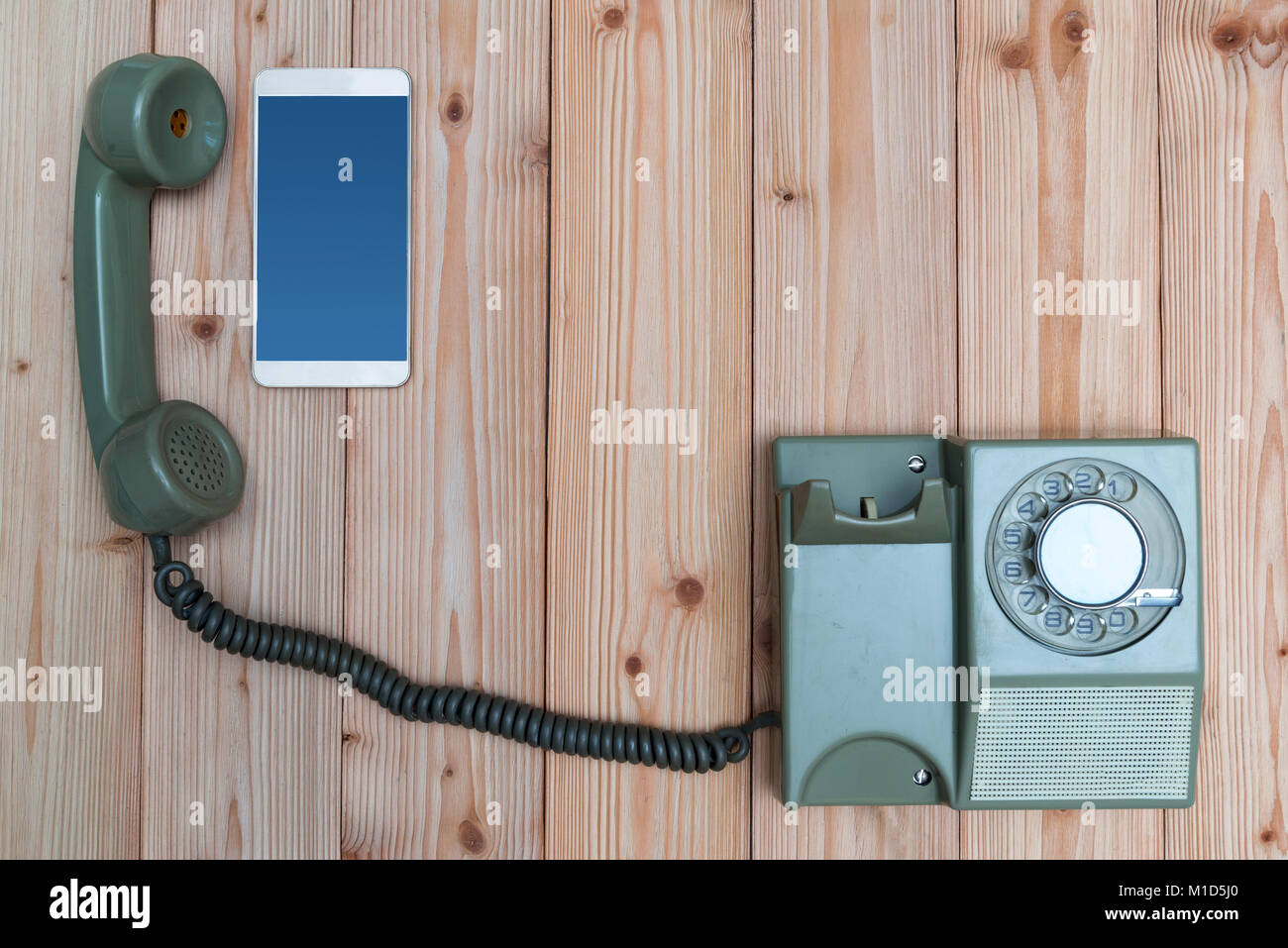 Retro rotary telephone or vintage phone with cable and new cell phone ...