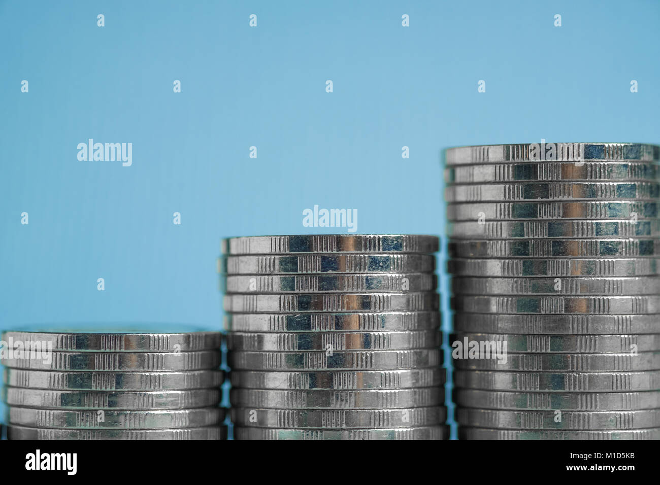 Increasing columns of coins, step of coin stacks with copy space for ...