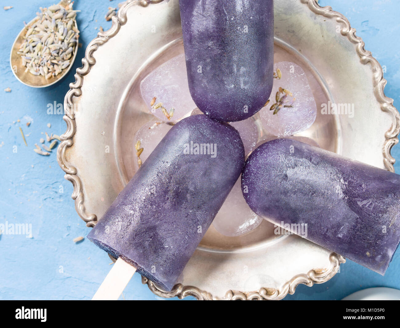 Lavender popsicles made of frozen orange and lemon juice with syrup in ...