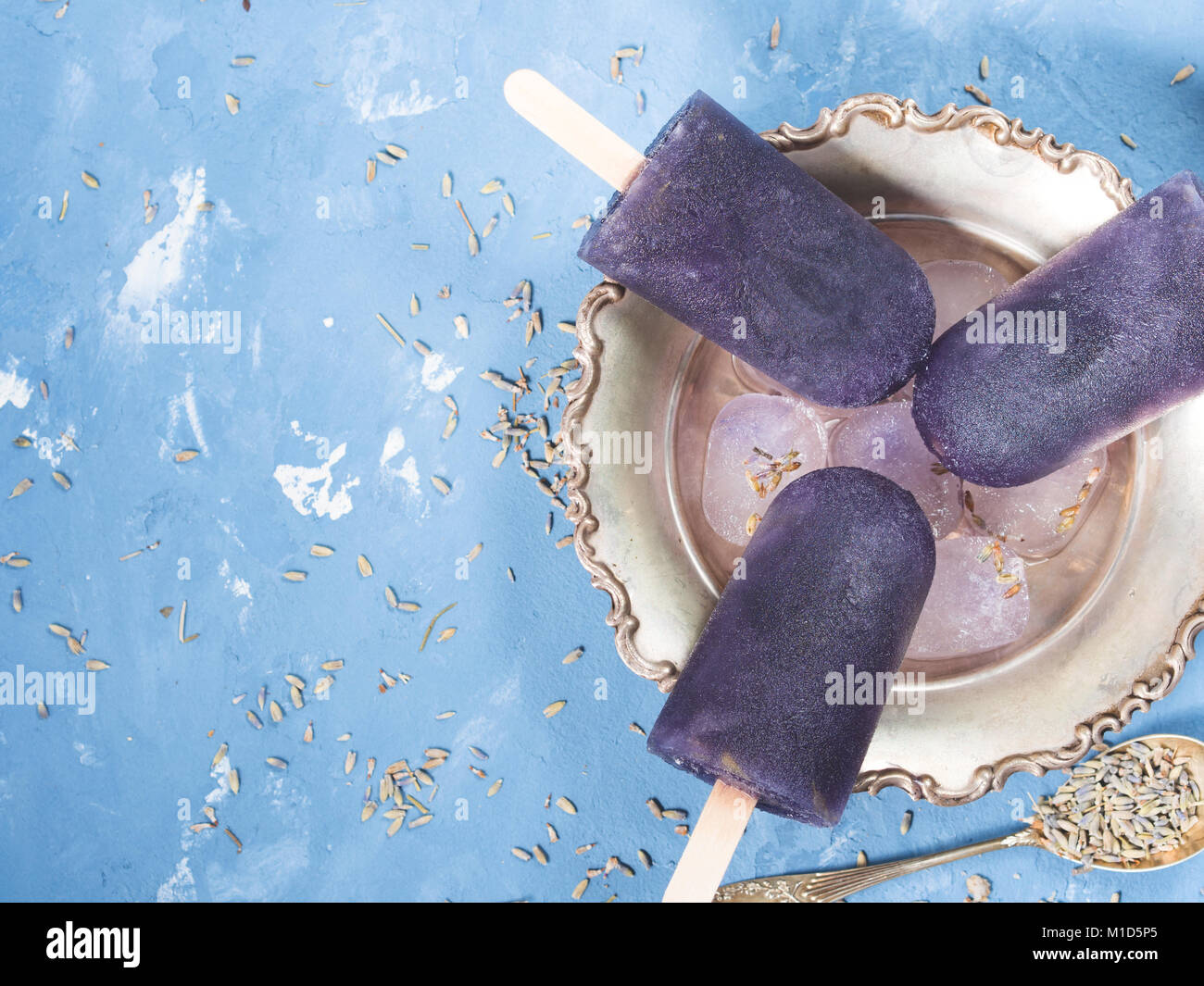 Lavender popsicles made of frozen orange and lemon juice with syrup in ...