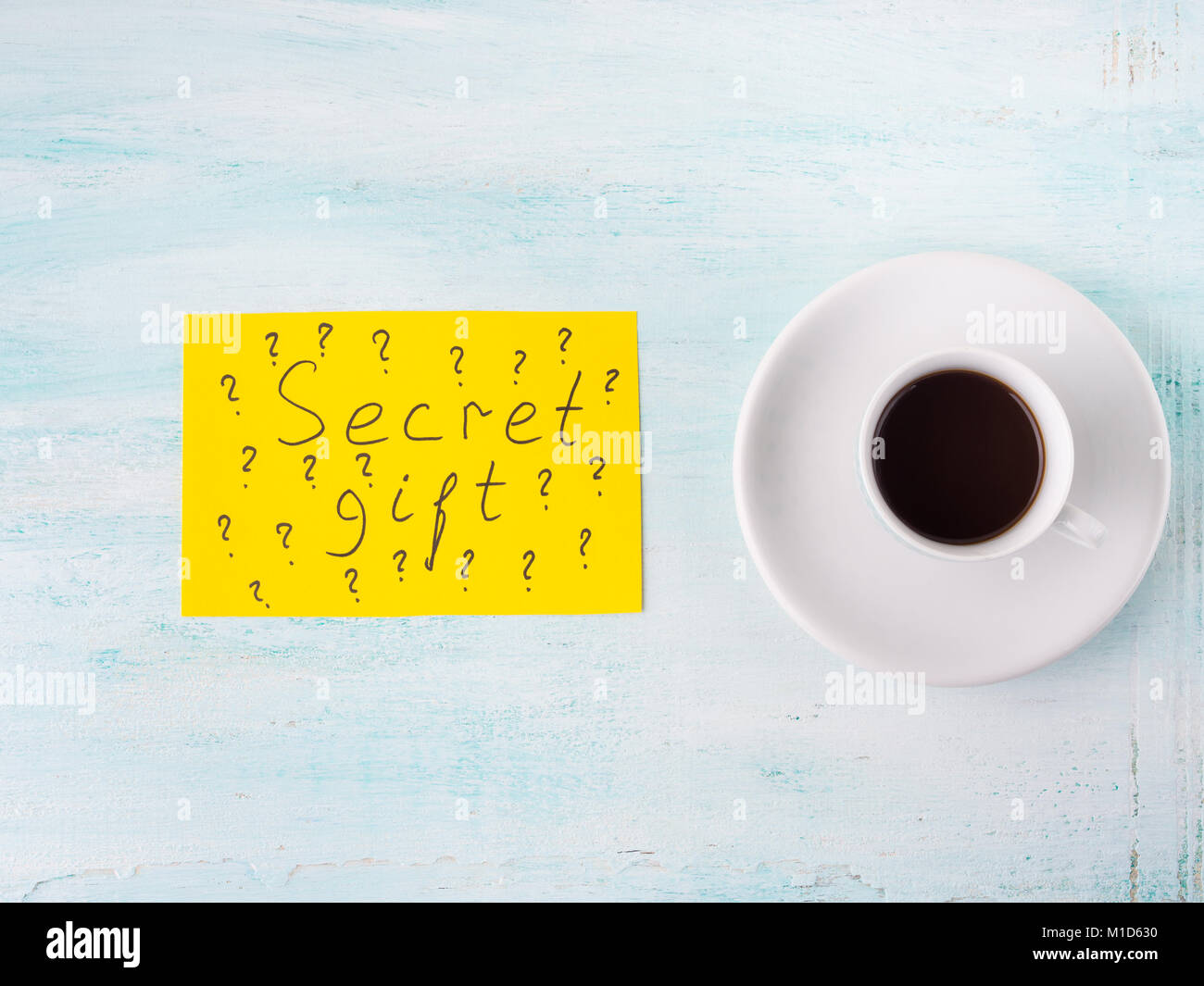 Cup of espresso coffee. Yellow card spelling words Secret gift concept ...