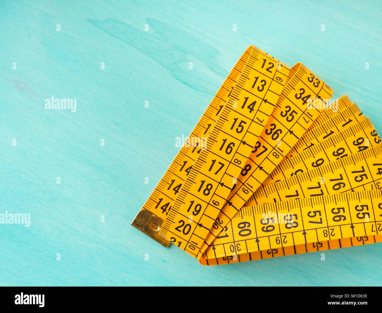 Measuring meter on green pastel background Stock Photo - Alamy