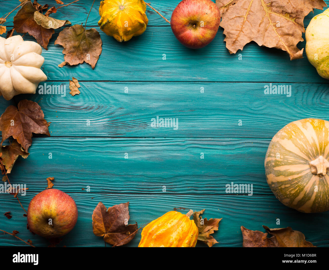 Moody green autumn background with pumpkin, apples, yellow leaves. Fall ...