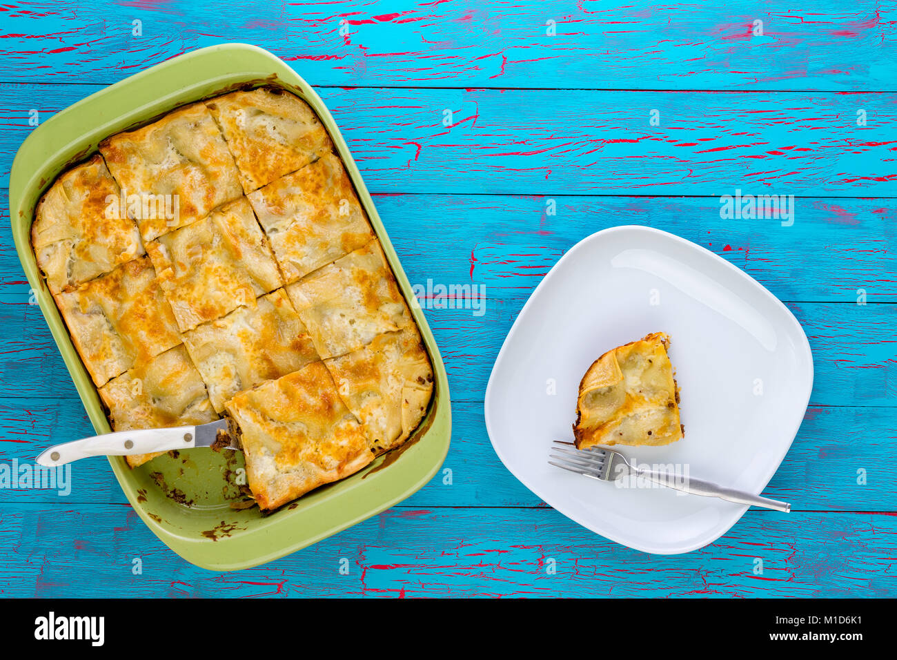 Freshly baked tart cut in portions and served with a single slice on a ...