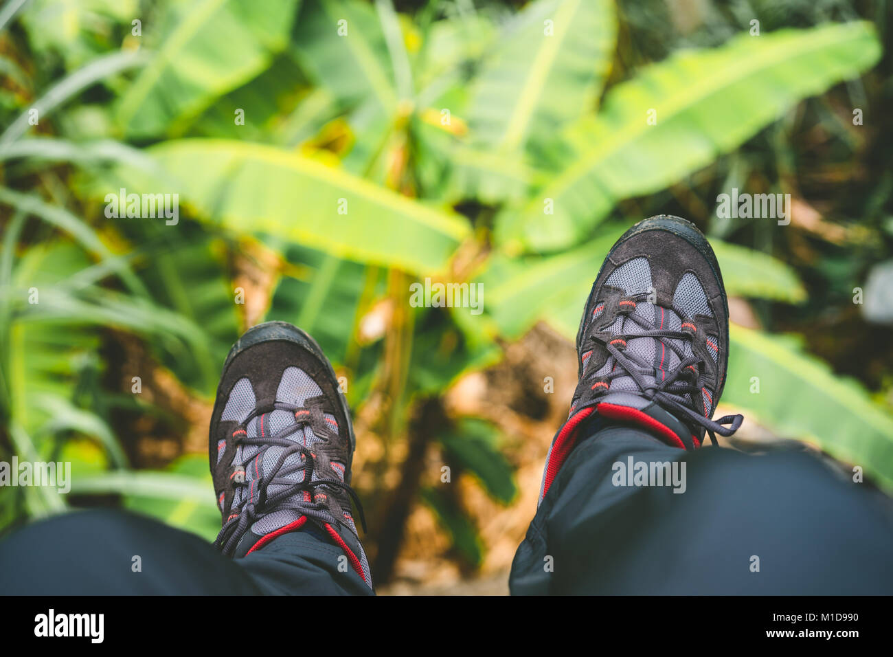 Hanging feet with trakking footwear after long hike from the mountains ...