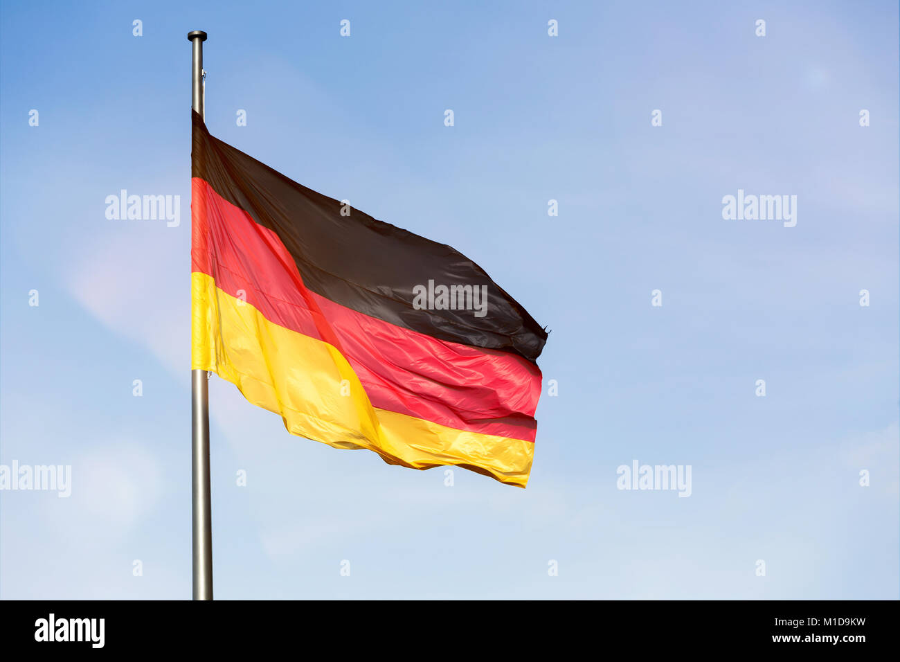 big german flag in front of a blue sky Stock Photo - Alamy