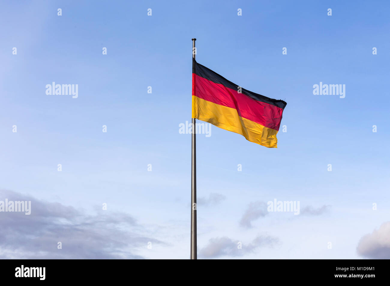 big german flag in front of a blue sky Stock Photo - Alamy