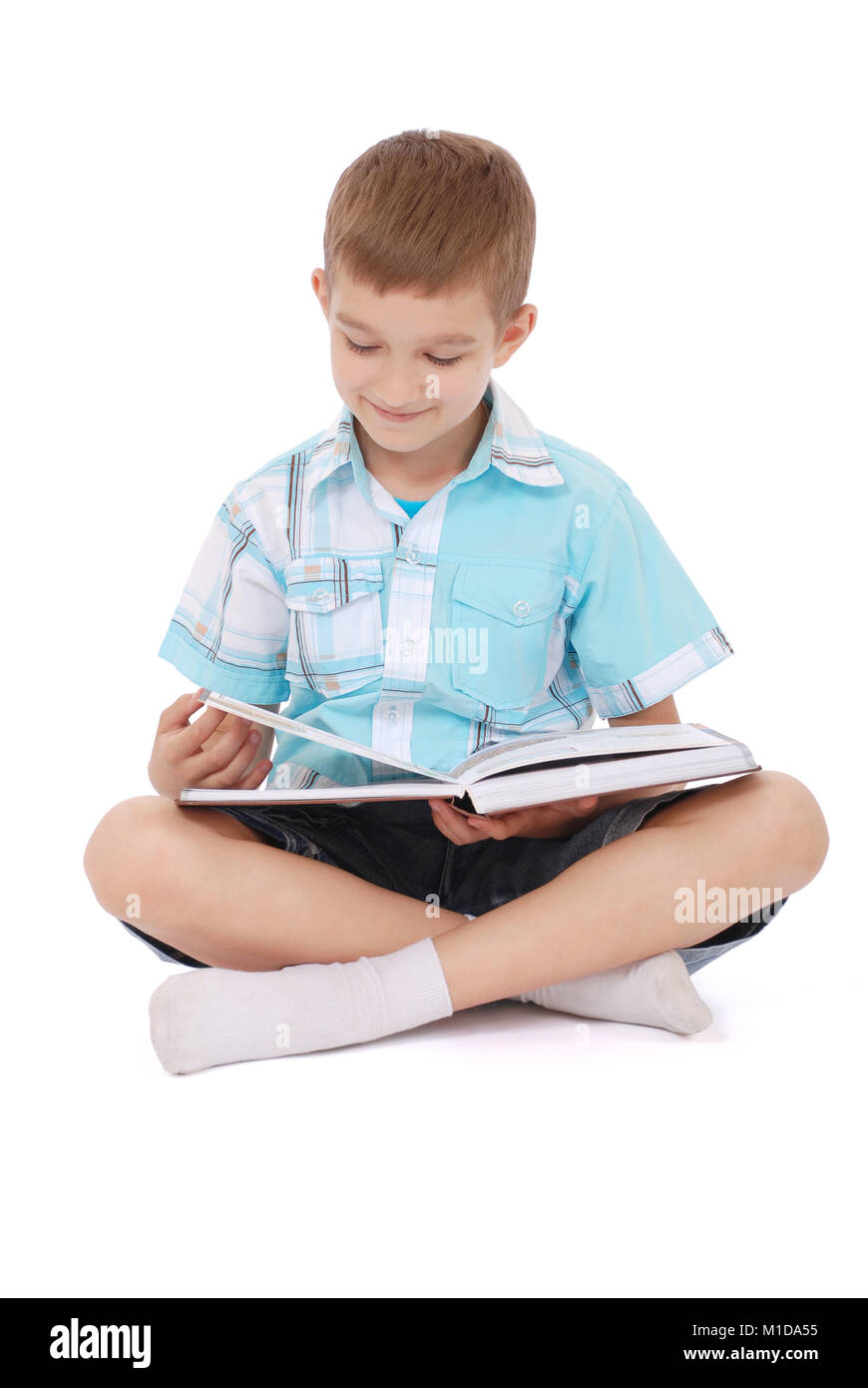 Young boy reading a picture book. Isolated on white Stock Photo - Alamy