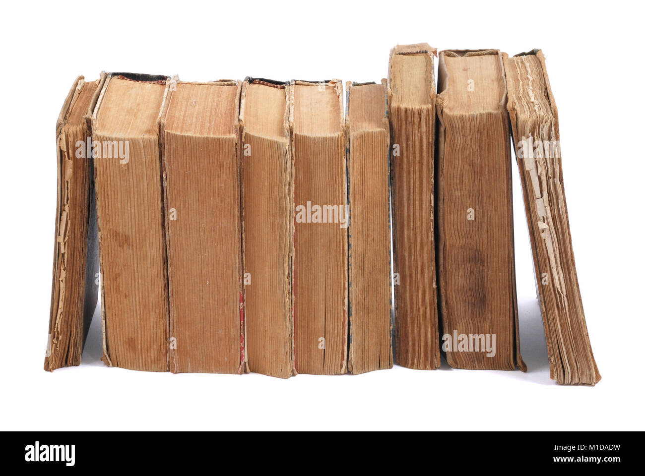 Row of old books on white background. Many of the books show lots of ...