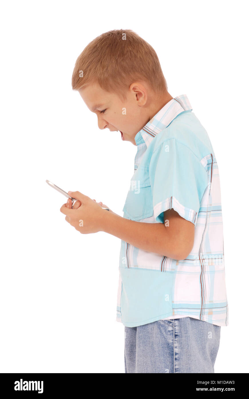 A young boy is furiously screaming into his cell phone Stock Photo - Alamy