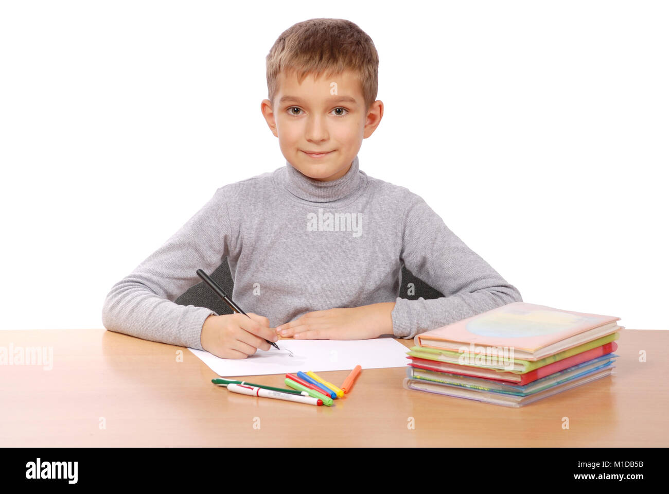 young boy doing school work on white background Stock Photo - Alamy