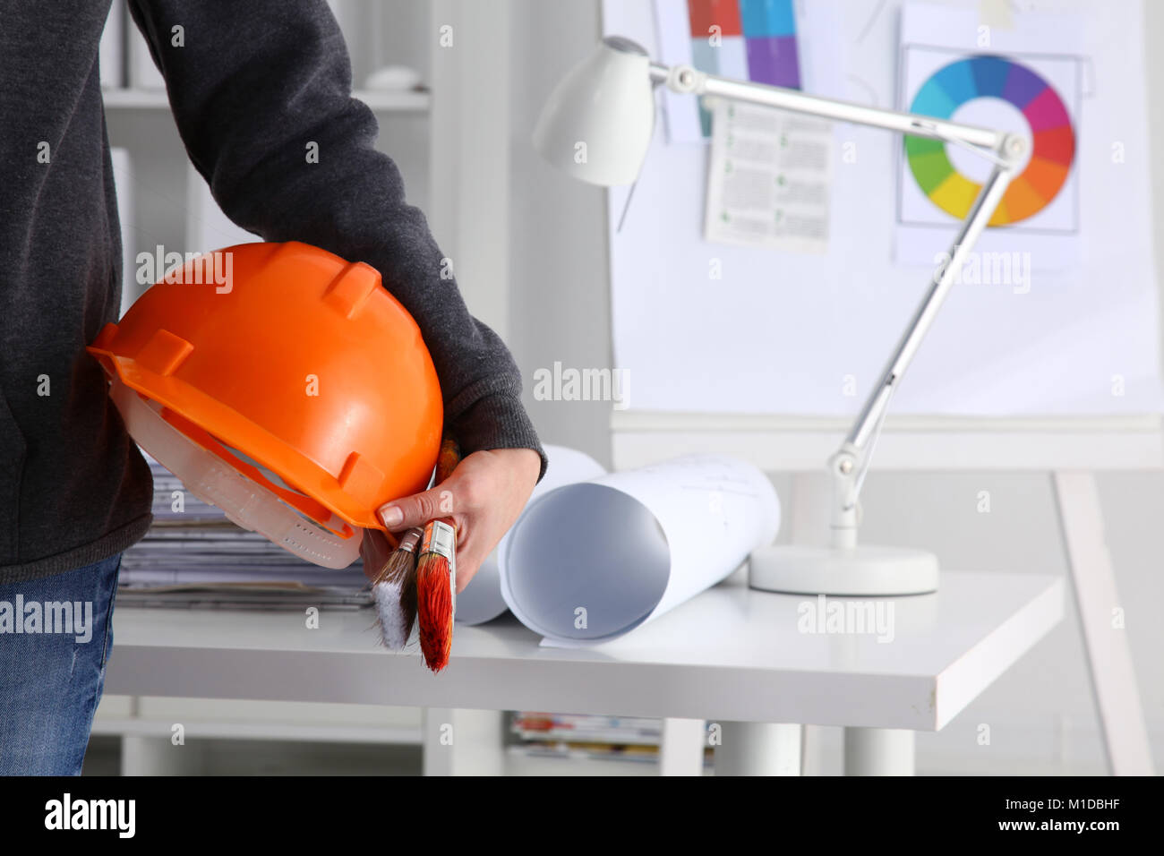 Man architect wearing suit holding helmet, standing in office Stock ...