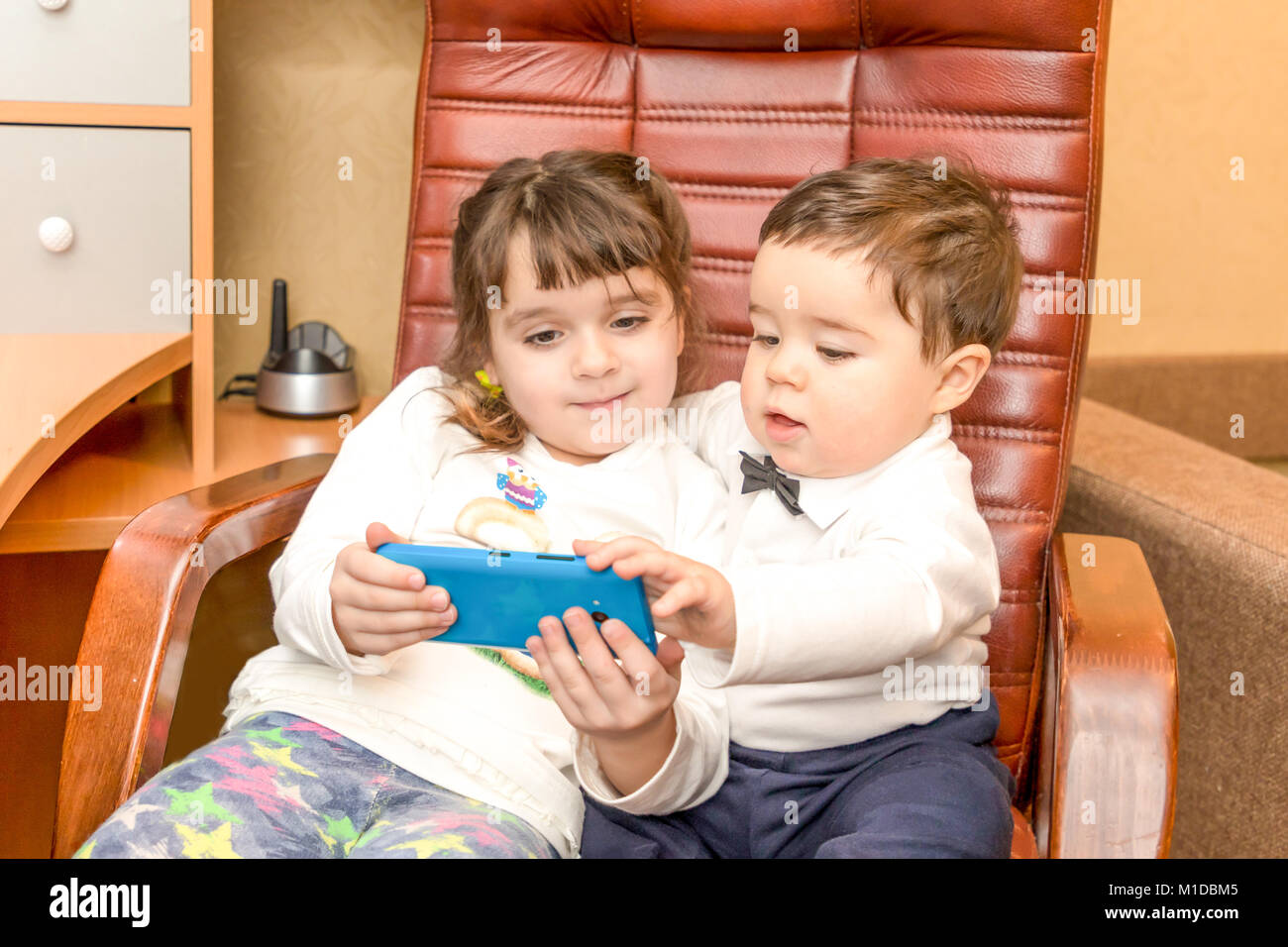 Little children with smartphone Stock Photo - Alamy