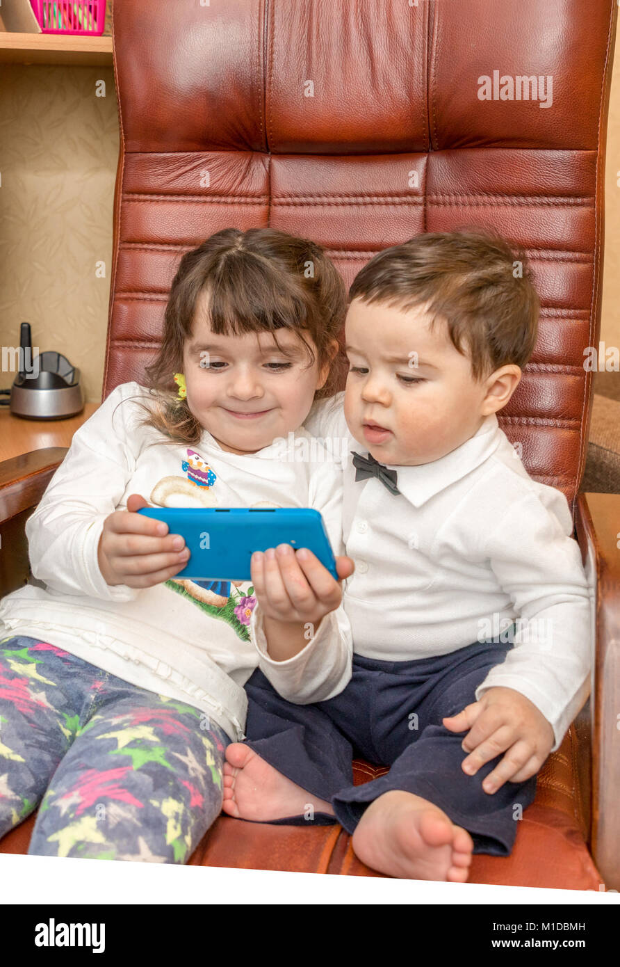 Little children with smartphone Stock Photo - Alamy