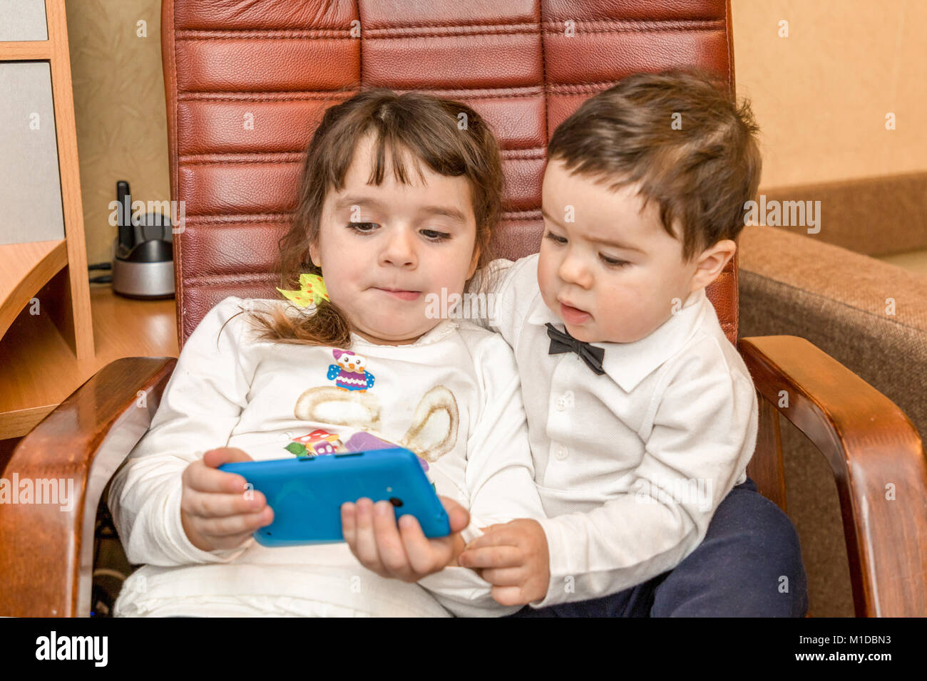 Little children with smartphone Stock Photo - Alamy