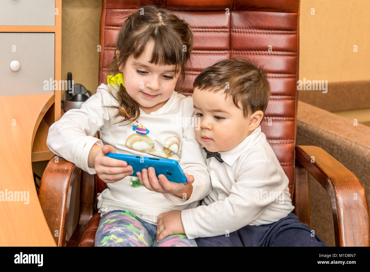 Little children with smartphone Stock Photo - Alamy