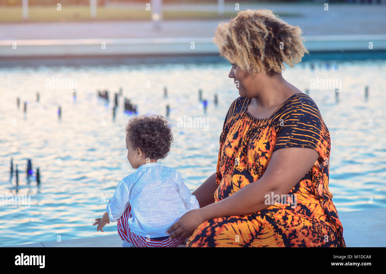 Mother and daughter having fun with fountain water Stock Photo - Alamy