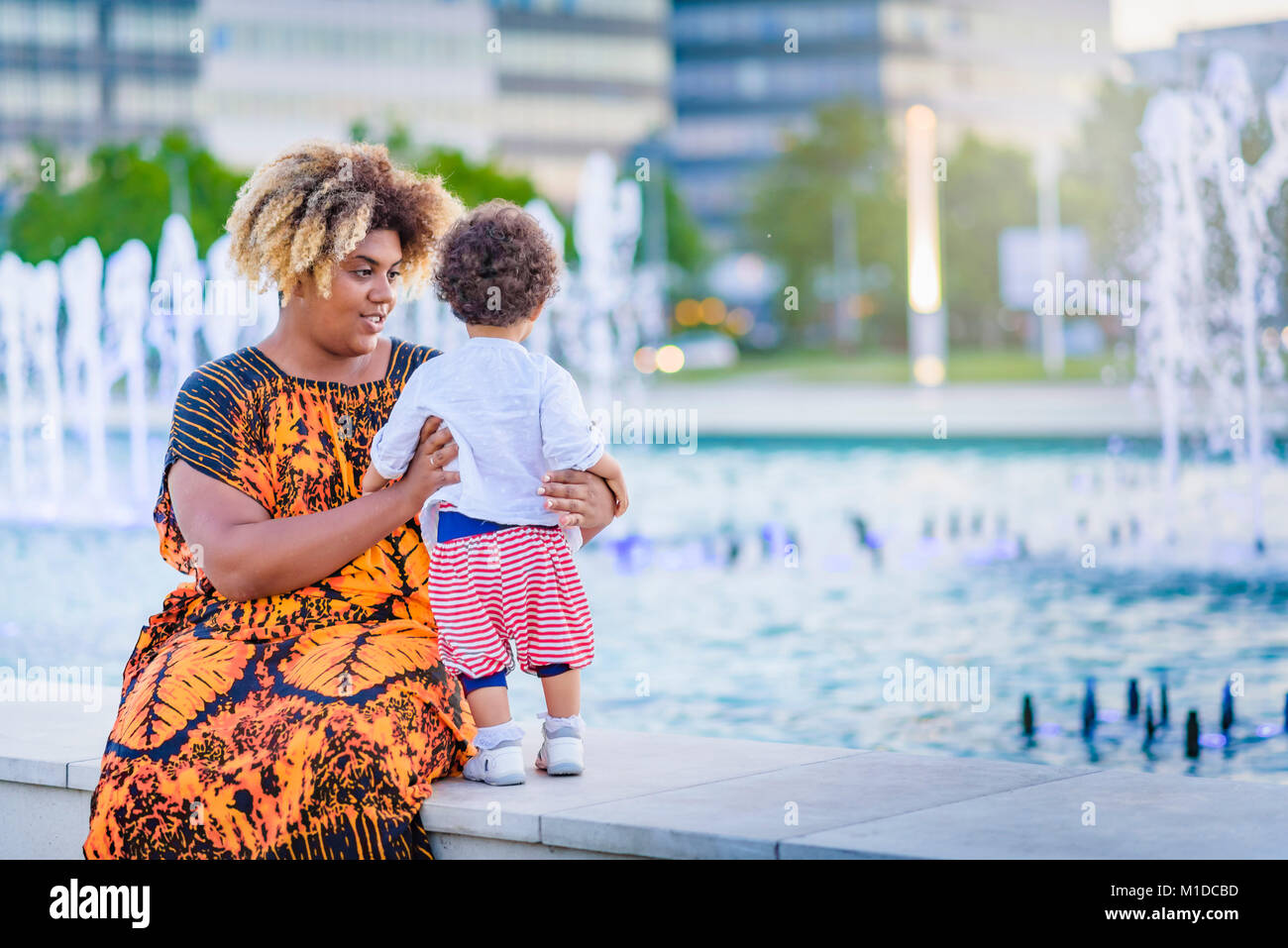 Mother and daughter having fun with fountain water Stock Photo - Alamy