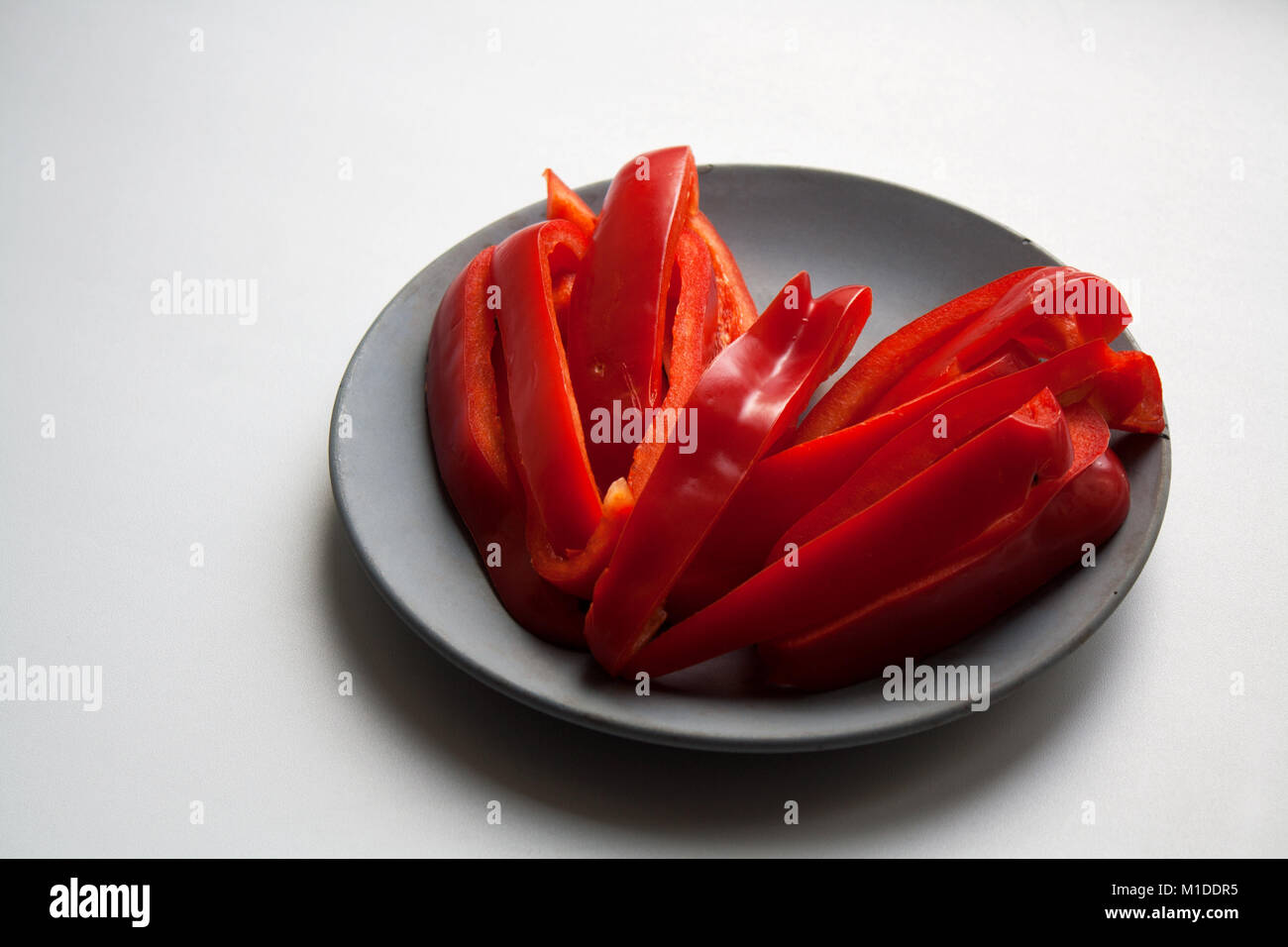 Freshly sliced red pepper heart shaped composition Stock Photo - Alamy
