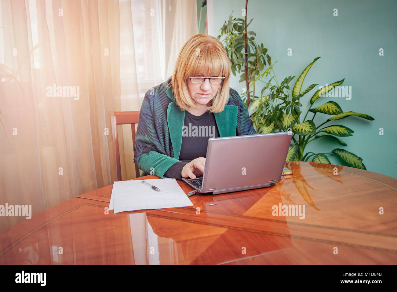 Elderly lady working from home Stock Photo - Alamy