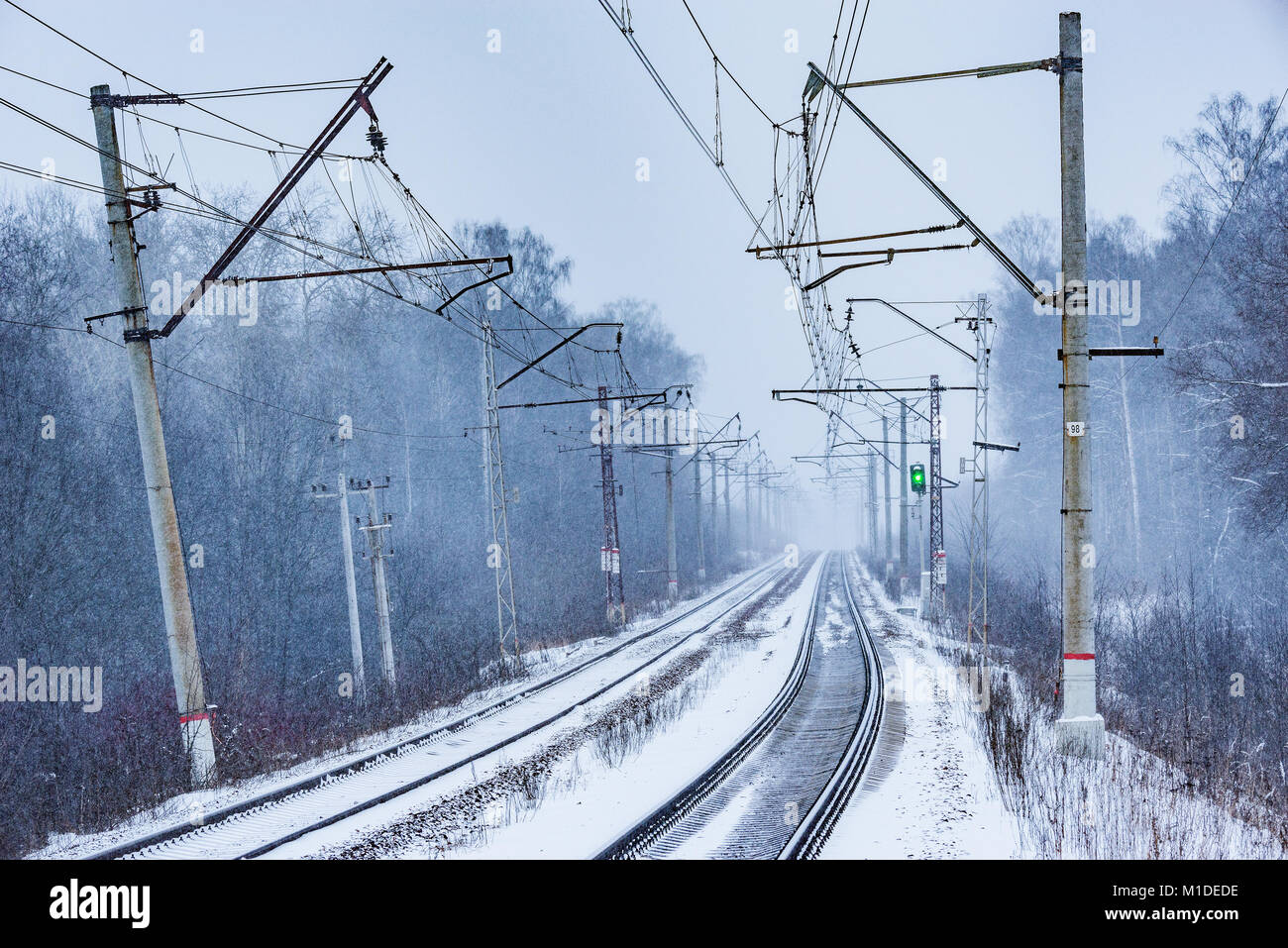Railway at cold snowy winter evening time Stock Photo - Alamy
