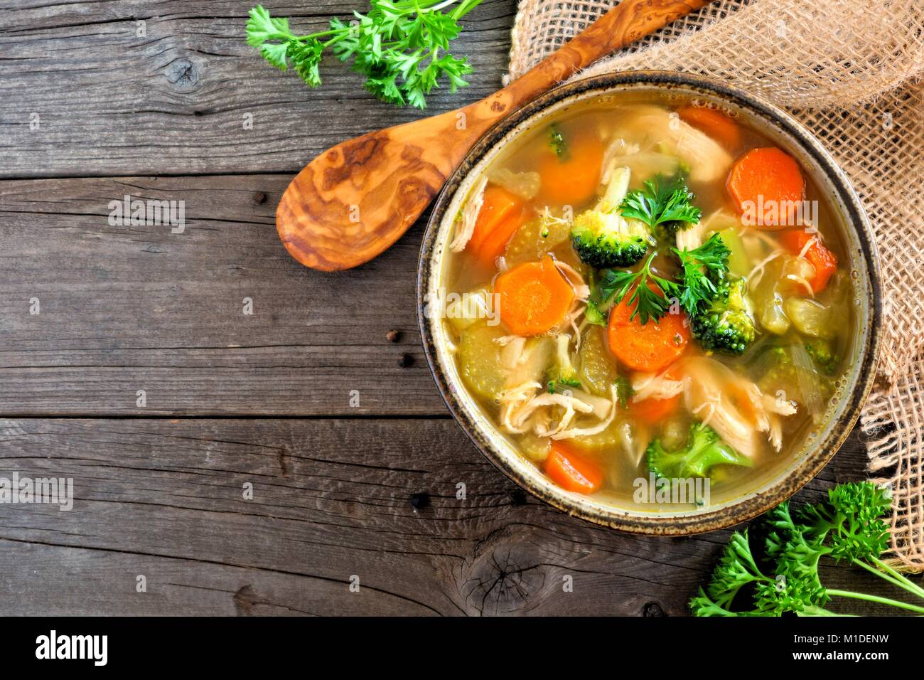 Homemade chicken vegetable soup, above view with copy space on a rustic ...