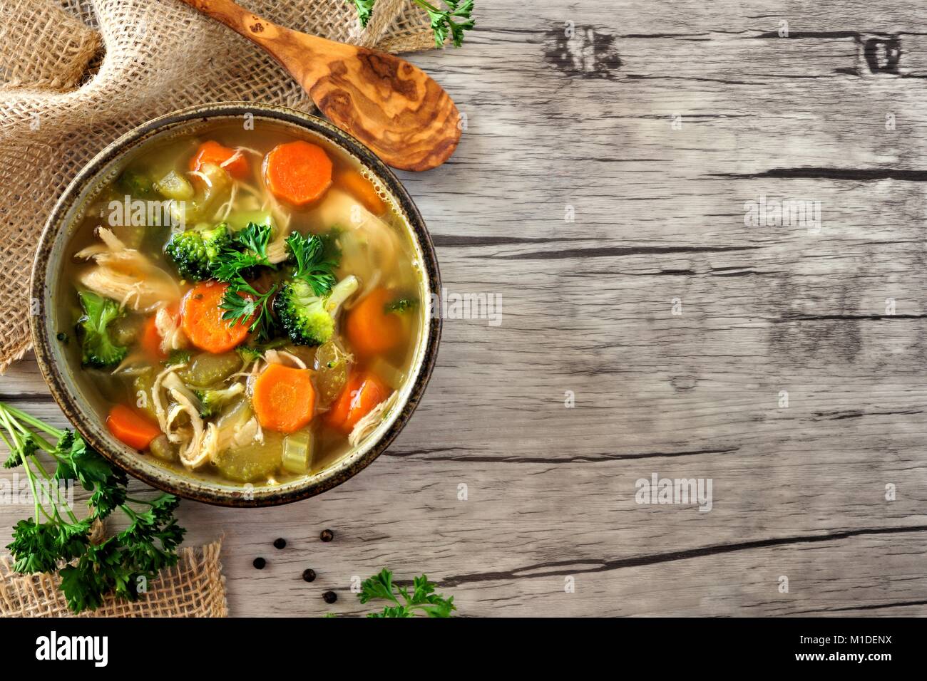 Homemade chicken vegetable soup, above view side border with copy space ...