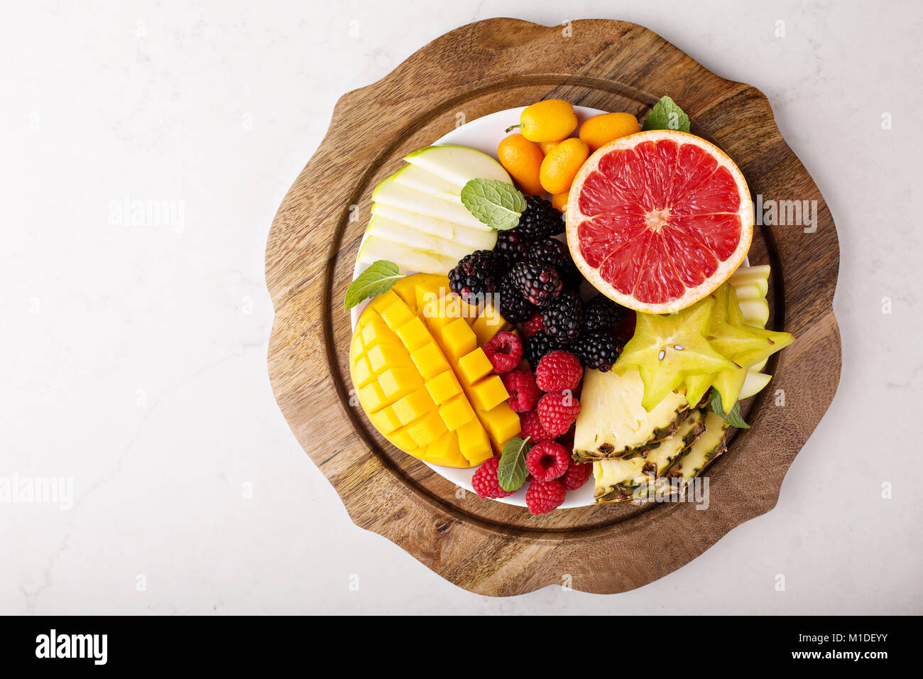 Fruit plate with mango, grapefruit and berries Stock Photo - Alamy