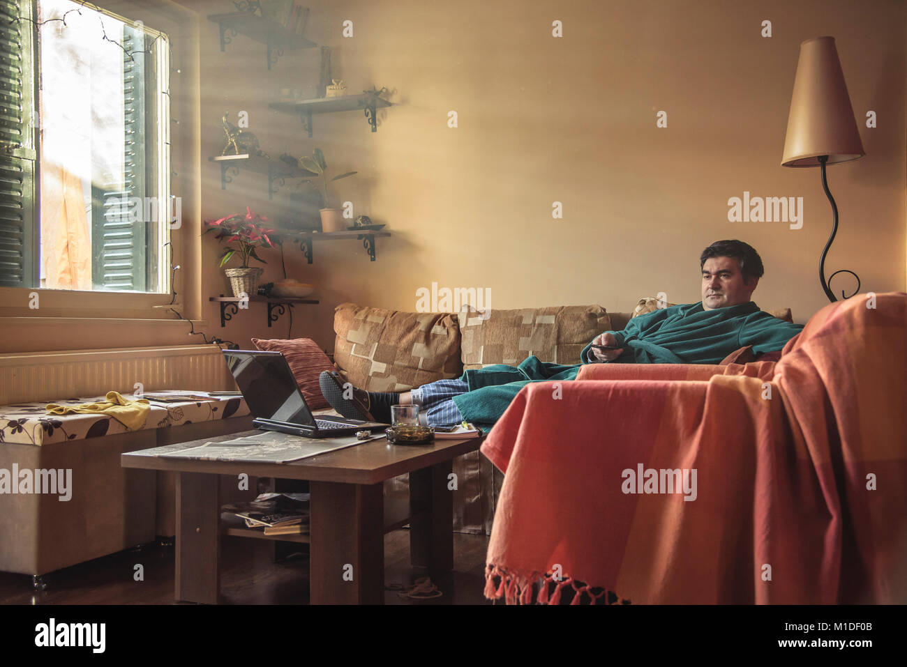 Morning tv programme a man is watching Stock Photo - Alamy