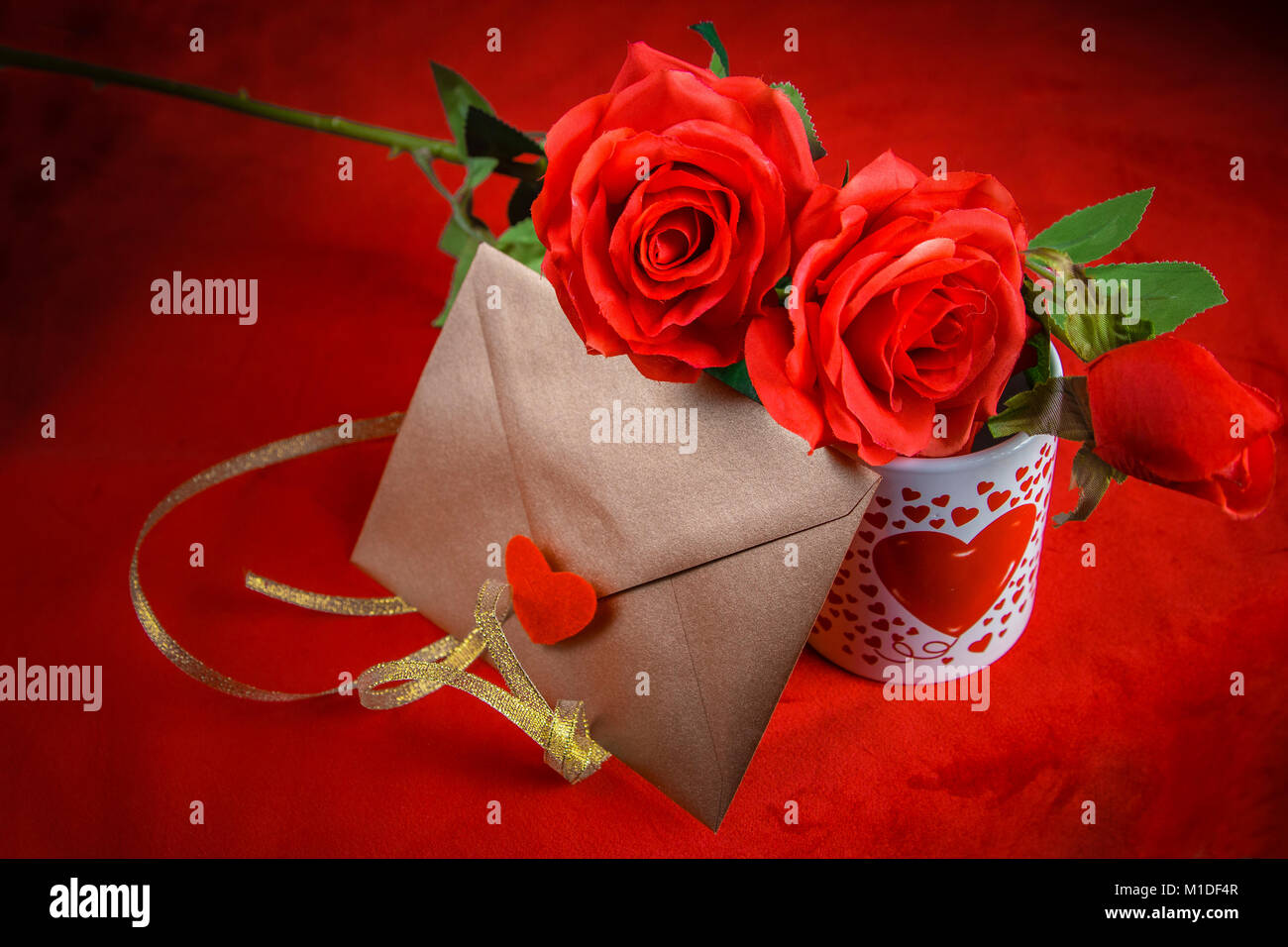 Valentine concept, love letter, rose and a heart cup on a red ...