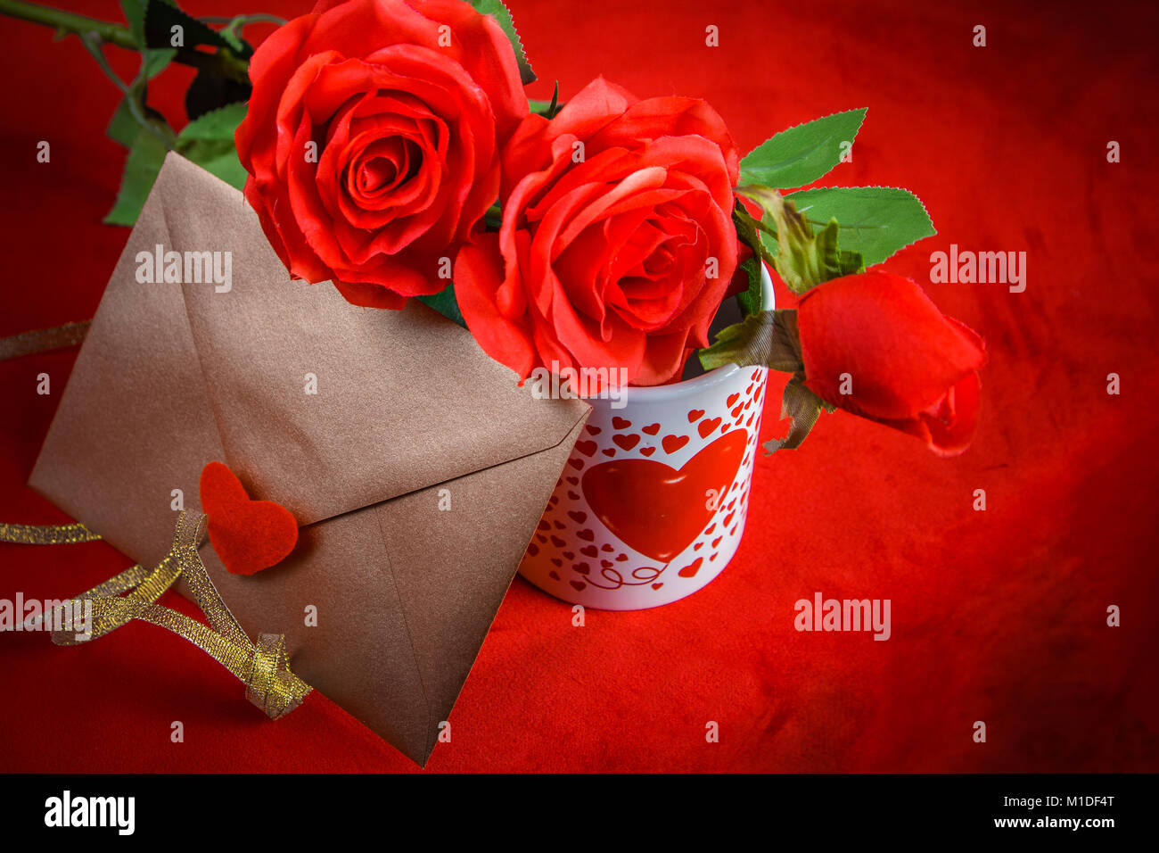 Valentine concept, love letter, rose and a heart cup on a red ...