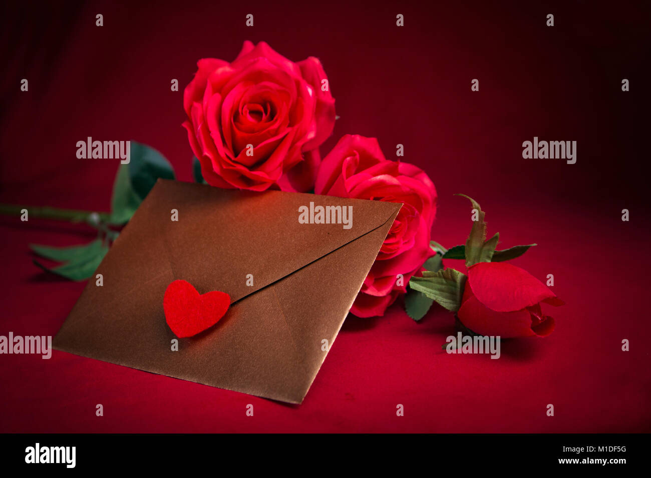 Valentine concept, love letter, rose and a heart cup on a red ...