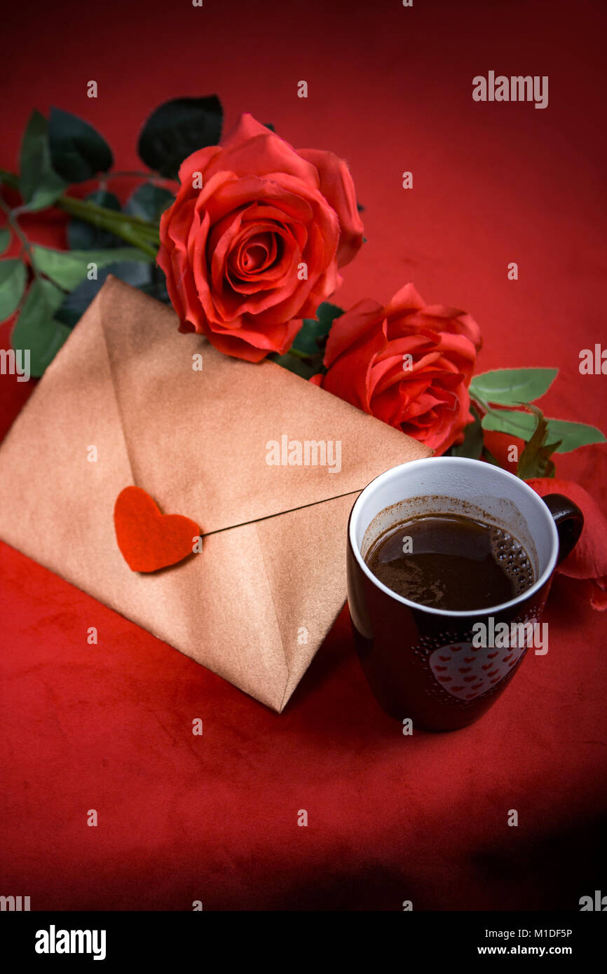 Valentine concept, love letter, rose and a heart cup on a red ...